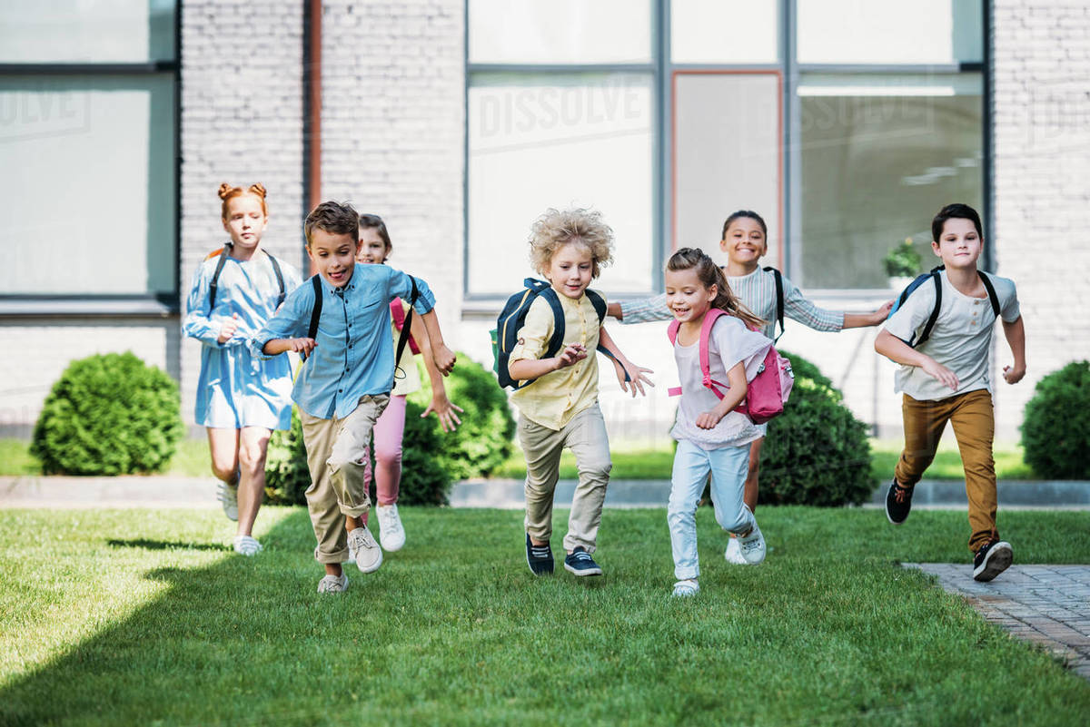 group of adorable pupils runing by school garden - Royalty-free Stock ...