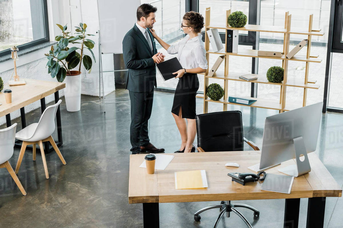 young business colleagues having conversation in office - Stock Photo ...