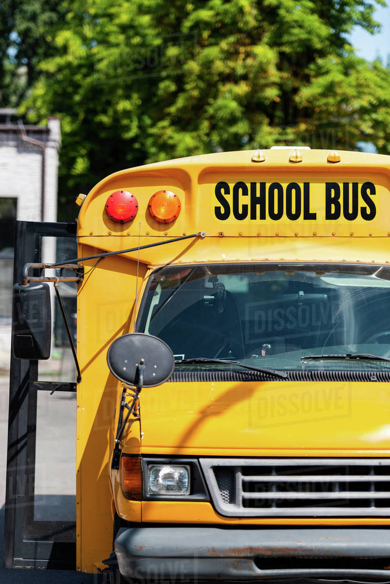 front view of traditional school bus with inscription over front glass ...