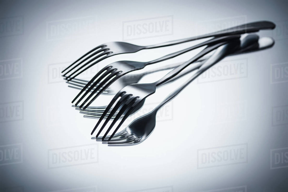 Close-up view of set of shiny metal forks on grey - Royalty-free Stock ...