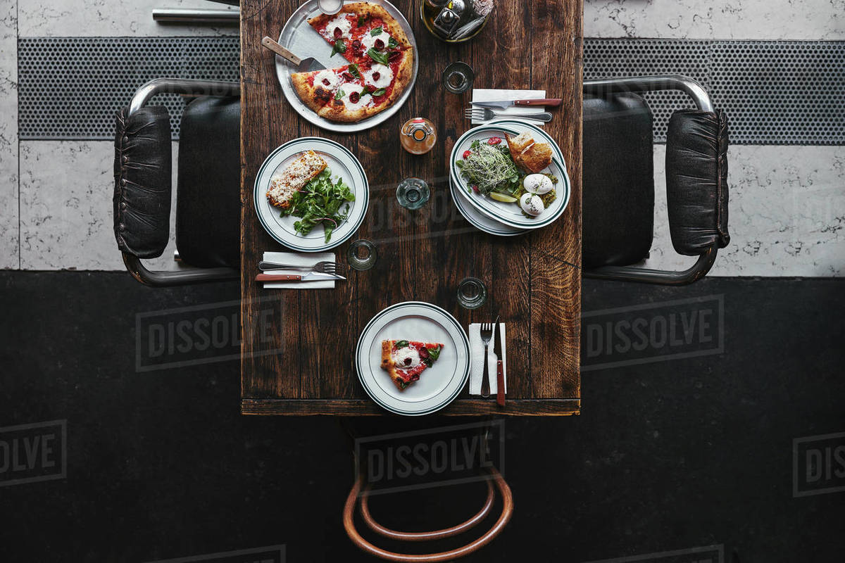 Top view of tasty Italian dishes and drinks on wooden rustic table at ...