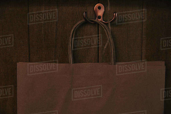 Close-up shot of blank paper bag hanging on wooden wall - Stock Photo ...