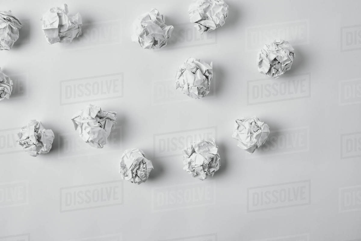 top view of spilled crumpled papers on white surface - Royalty-free ...
