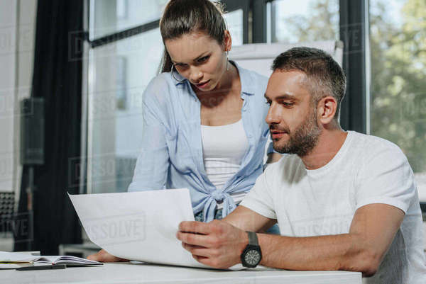 businesspeople looking at documents at table in office - Royalty-free ...