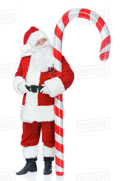 santa claus standing with big christmas candy cane isolated on white ...