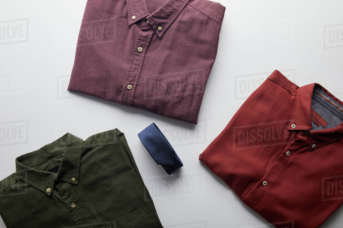 Elevated view of three colored shirts isolated on white - Royalty-free ...