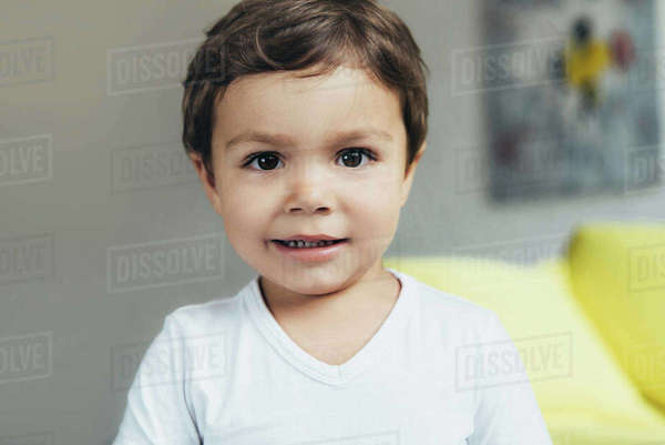 Portrait of adorable smiling kid at home - Stock Photo - Dissolve