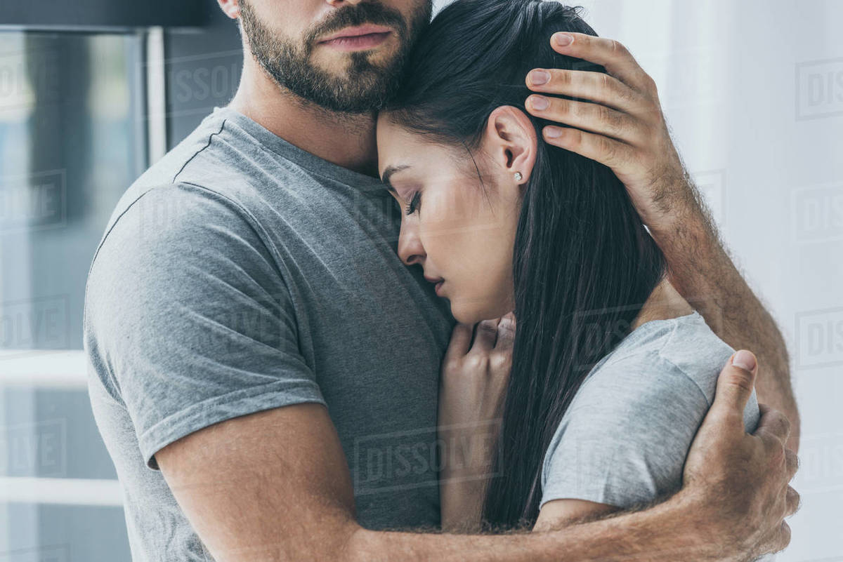 Cropped Shot Of Bearded Man Hugging And Supporting Young Sad Woman