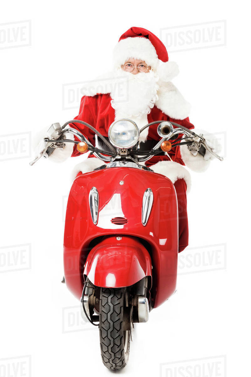 Santa claus riding vintage scooter and looking at camera isolated on ...