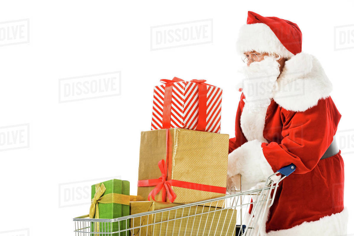 Santa claus with shopping cart full of gift boxes isolated on white ...