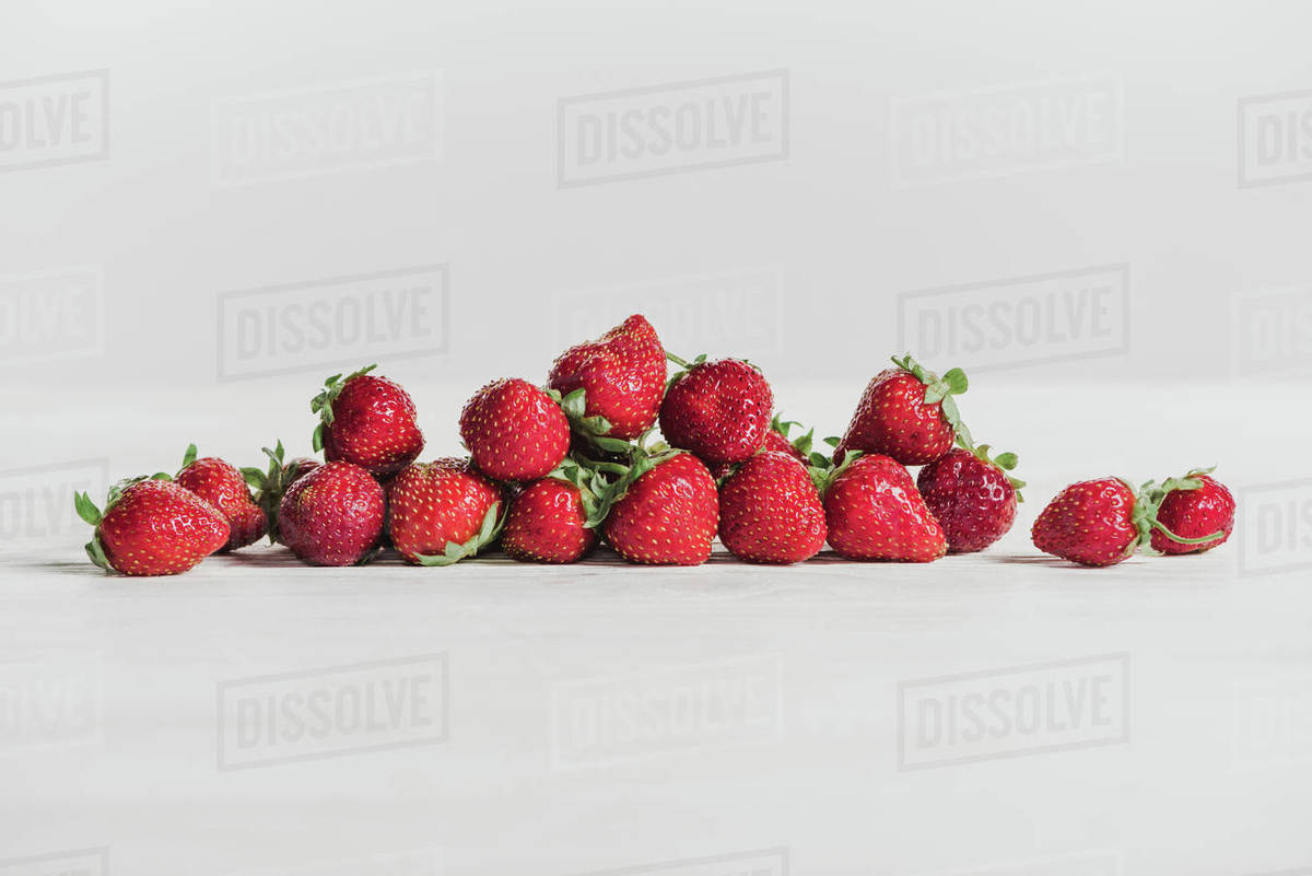 Close-up shot of pile of strawberries lying on white - Royalty-free ...