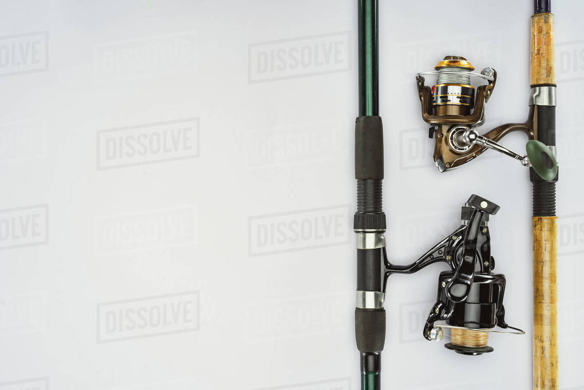 Top view of two arranged fishing rods isolated on white, minimalistic ...