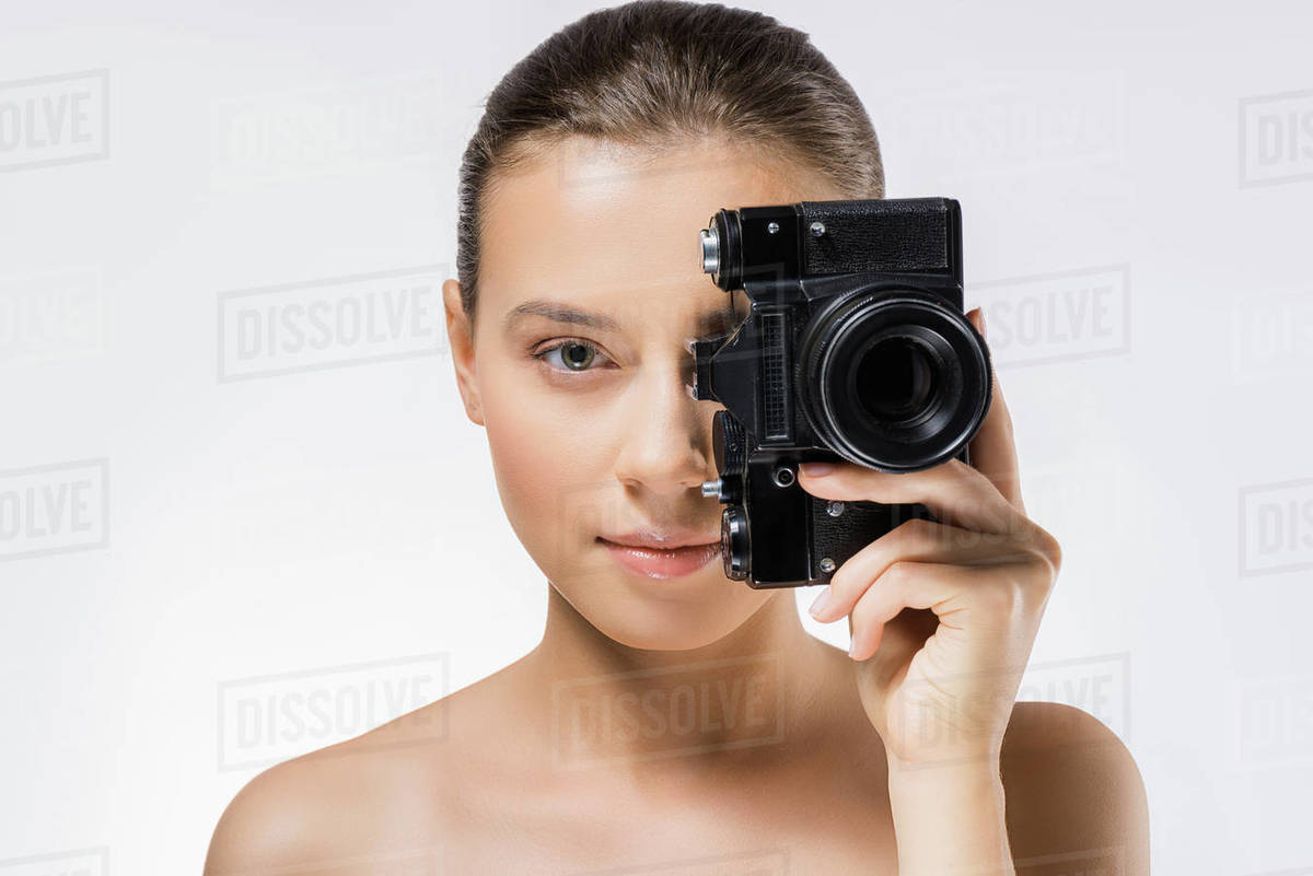 Young woman hiding face behind black camera - Royalty-free Stock Photo ...