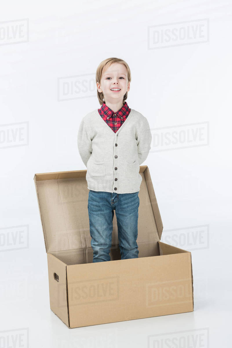 Smiling boy standing in cardboard box isolated on white - Royalty-free ...