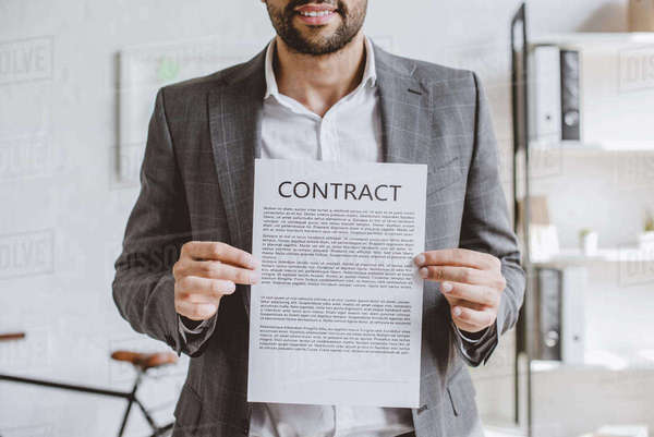 Cropped image of cheerful businessman showing contract in office ...
