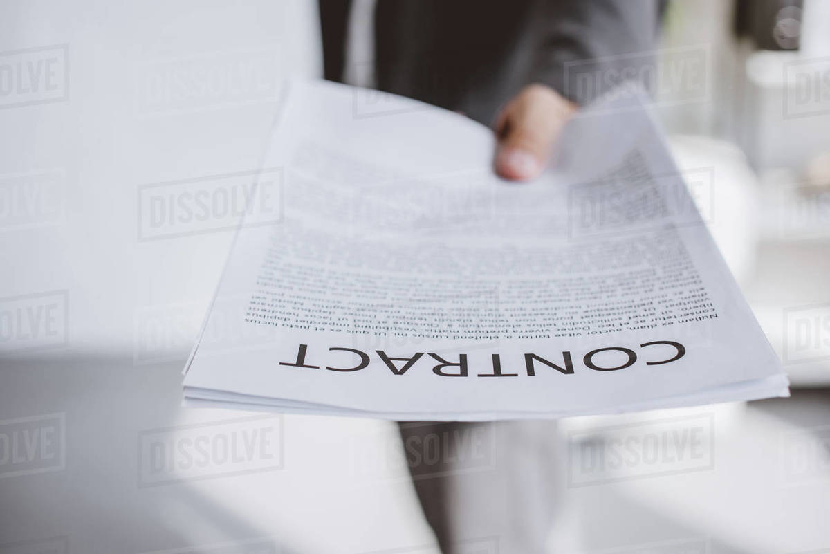 Cropped image of businessman showing contract in office - Royalty-free ...