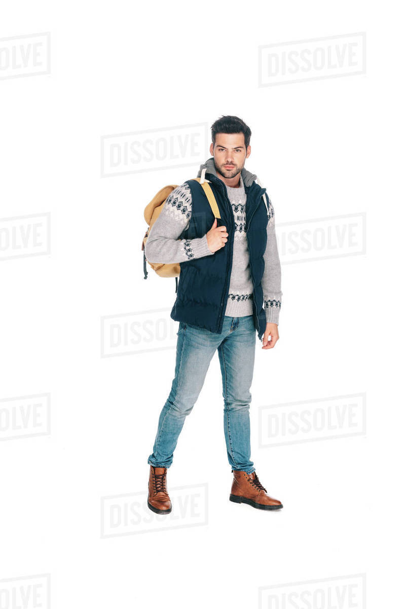 full length view of handsome young man with backpack looking at camera ...