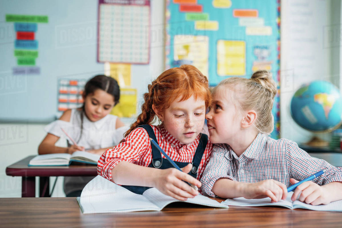 beautiful little girls gossiping in class - Royalty-free Stock Photo ...