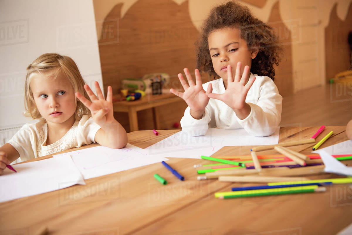 Multicultural kids showing numbers with fingers in kindergarten ...
