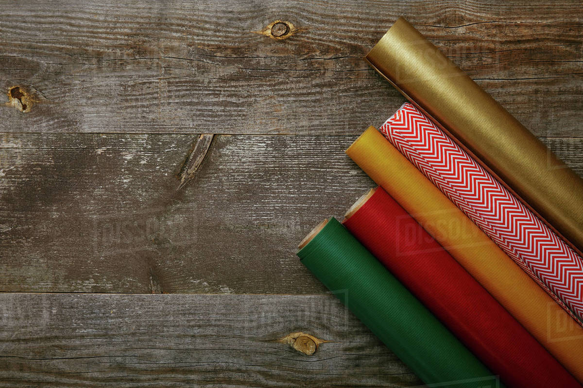 Top view of arranged wrapping papers of different colors on wooden ...