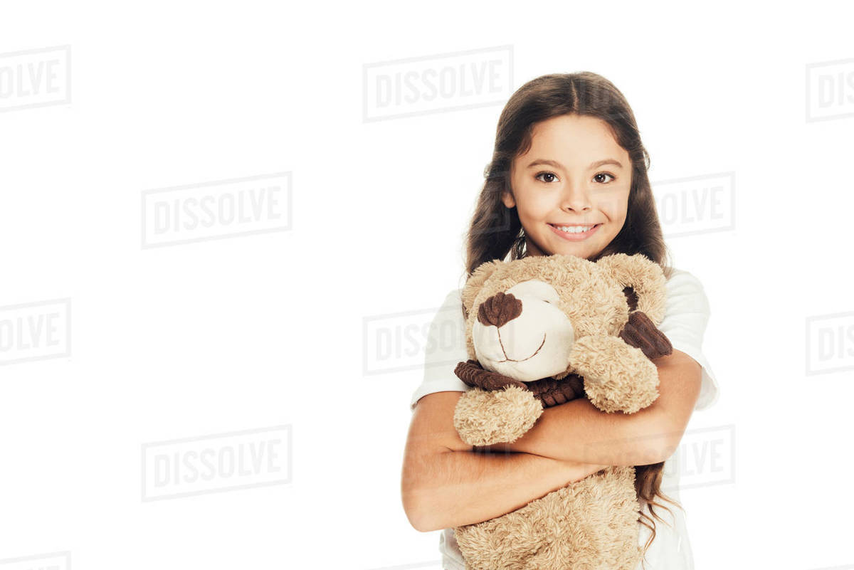 Smiling adorable child hugging teddy bear isolated on white and looking ...