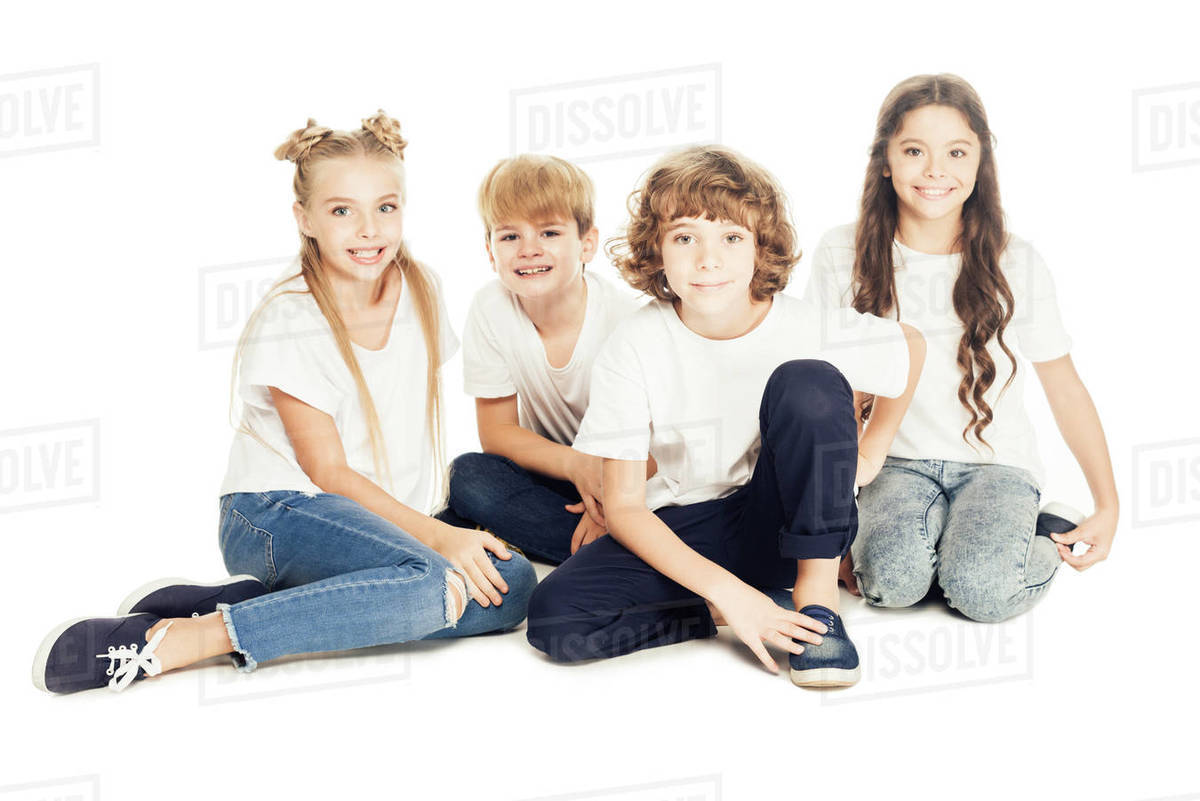 Group of beautiful happy kids sitting together and smiling at camera ...