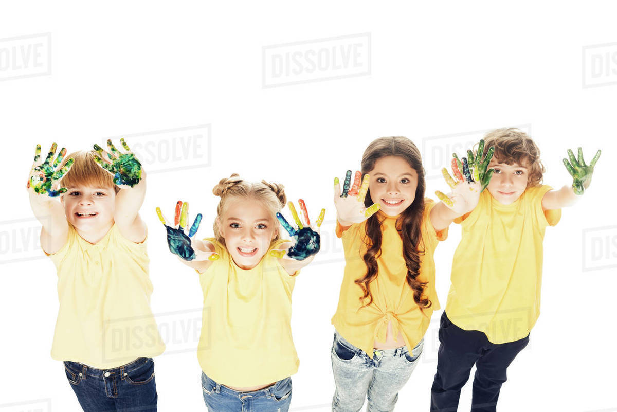 High angle view of adorable happy kids showing hands in paint and ...