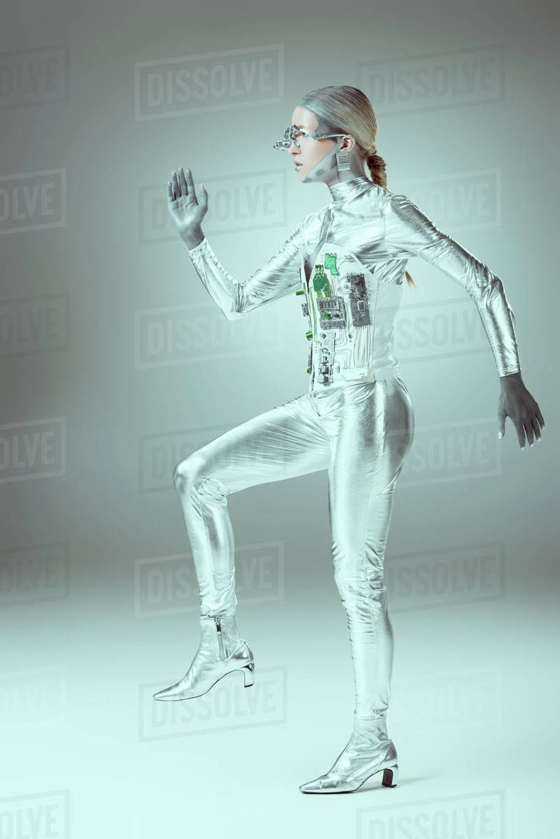 Side view of futuristic cyborg walking on grey, future technology ...