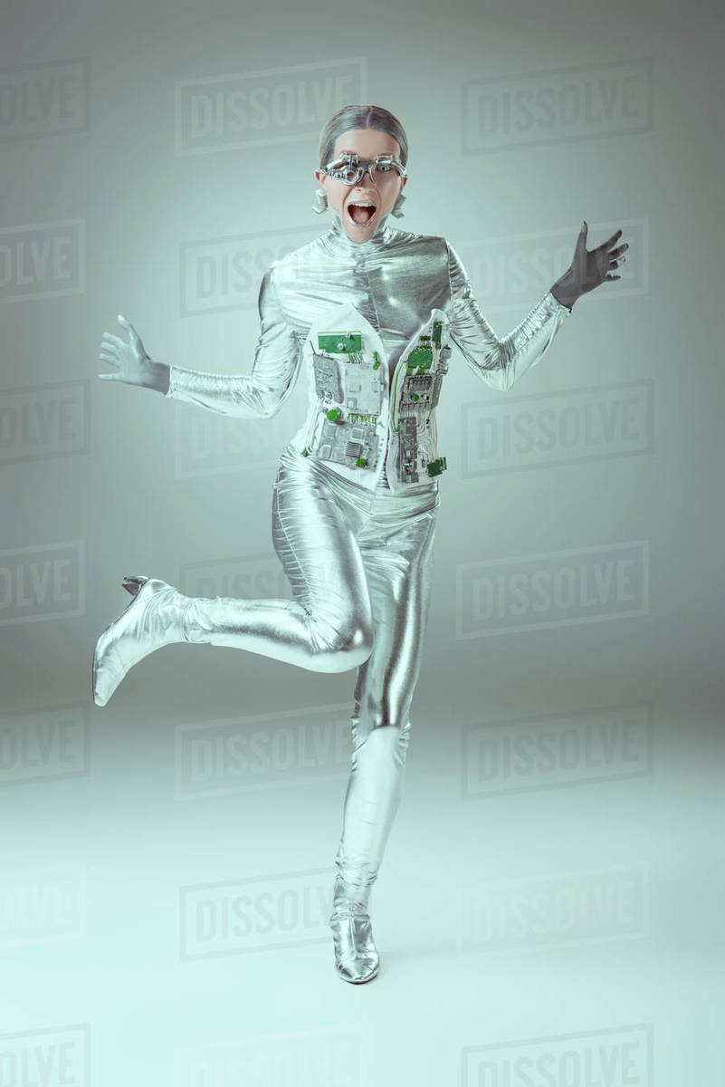 Full length view of silver woman robot screaming on grey, future ...