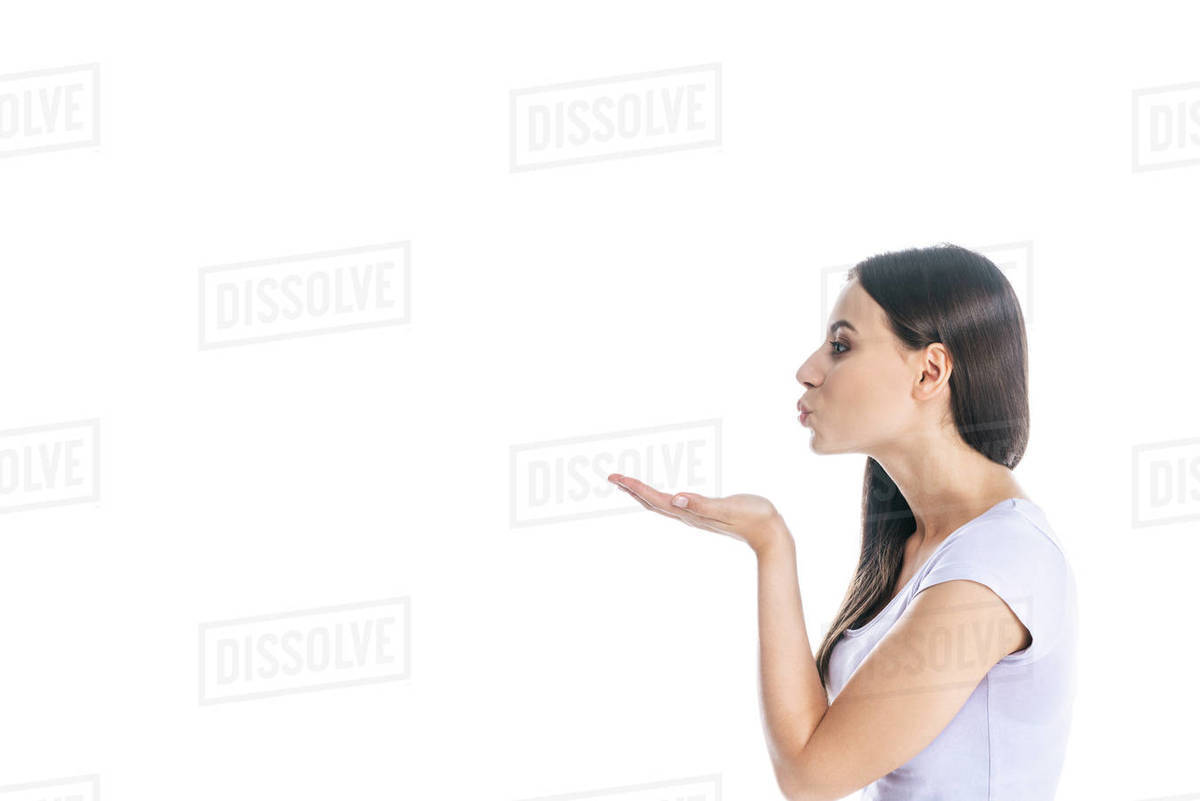 Side view of young beautiful woman blowing kiss isolated on white ...
