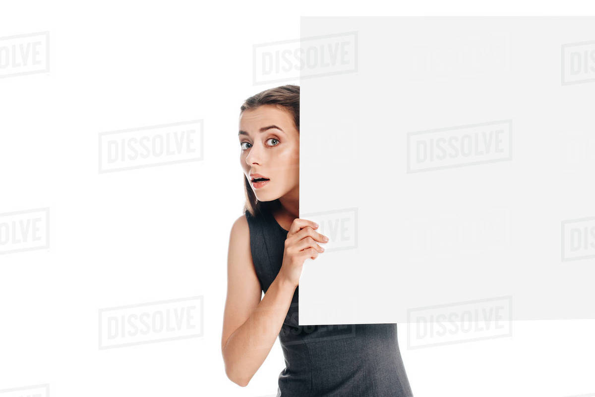 Portrait of shocked young woman with blank banner isolated on white ...