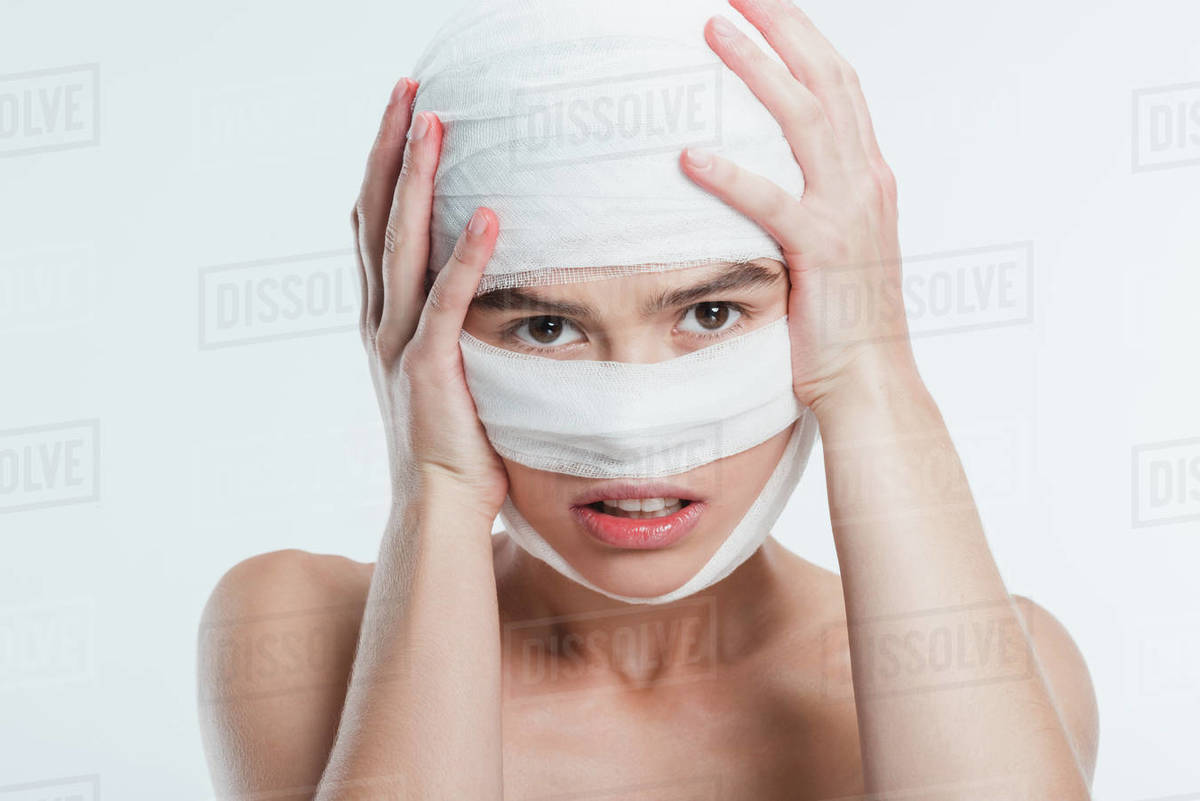 Close up of woman with bandages over head isolated on white - Stock ...