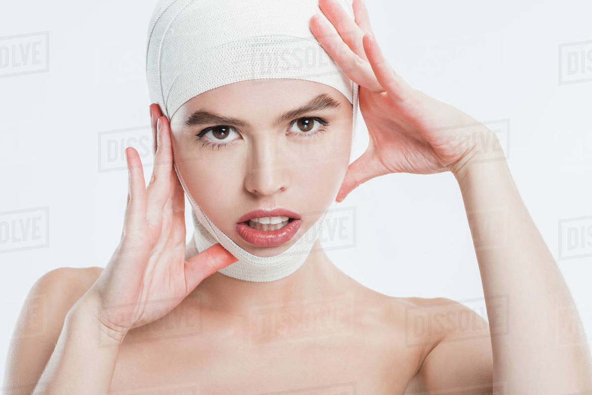 Close up of woman with bandages over head after plastic surgery ...