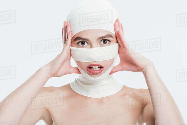 Close up of woman with bandages over head after plastic surgery ...