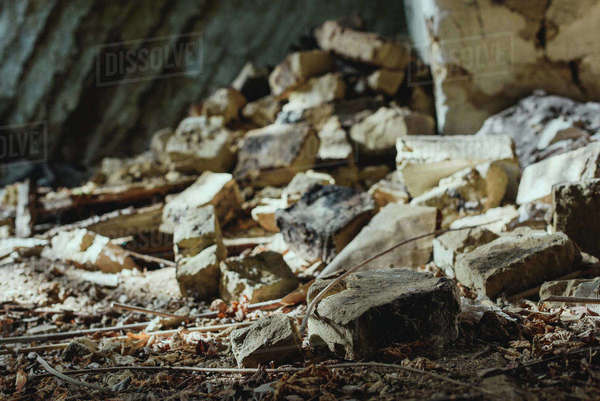 Abandoned building with scattered damaged bricks on floor - Stock Photo ...