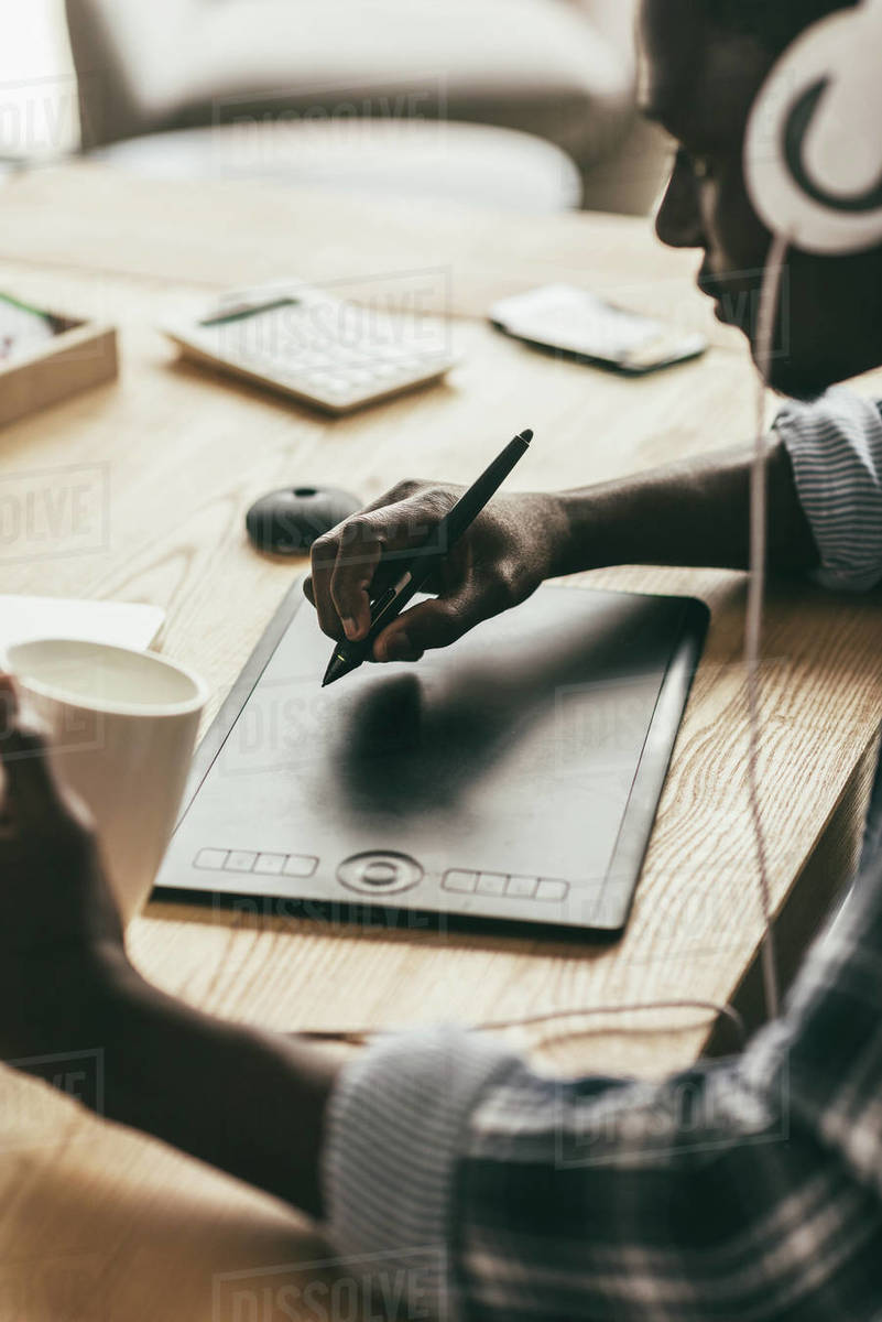 Young man in headphones drawing with digital tablet - Royalty-free ...