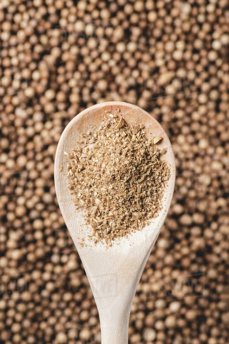 Top view of wooden spoon with coriander powder and seeds - Royalty-free ...
