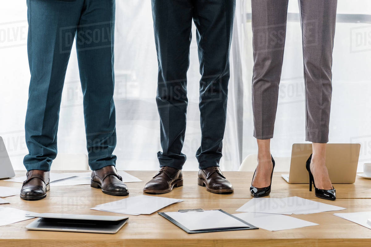 Business people standing at wooden table in office - Royalty-free Stock ...