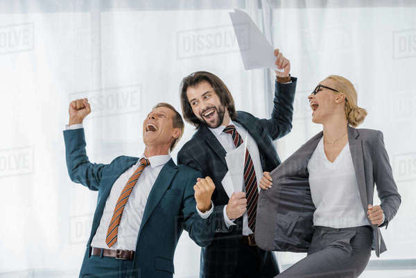 Happy office workers rejoicing great deal in office - Stock Photo ...