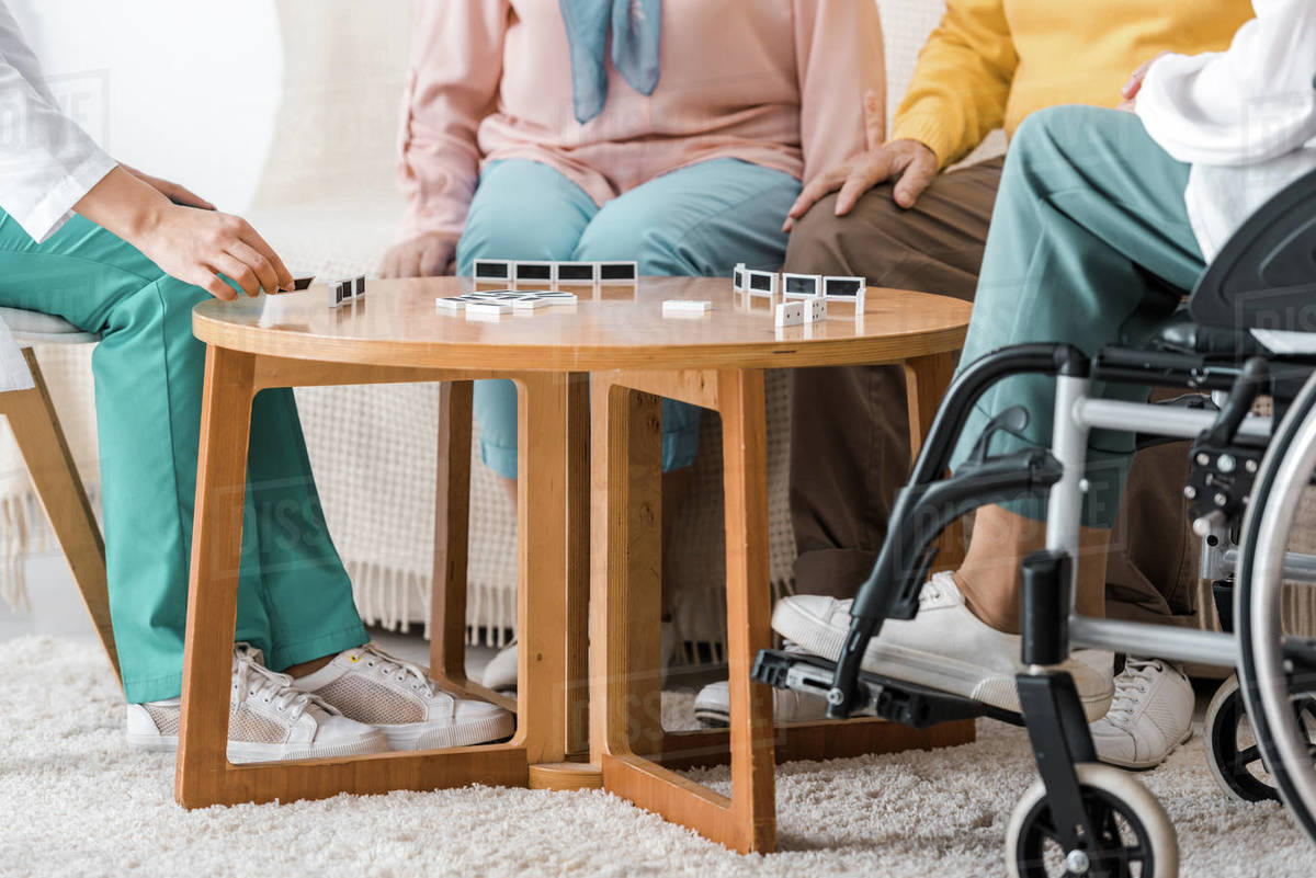 Doctor playing domino at table with senior patients - Stock Photo ...