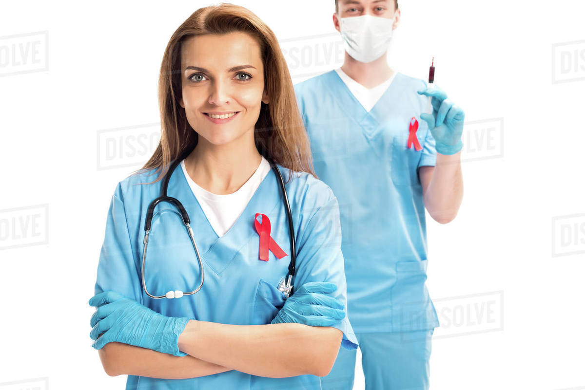 Doctors standing with red ribbons and syringe isolated on white, world ...