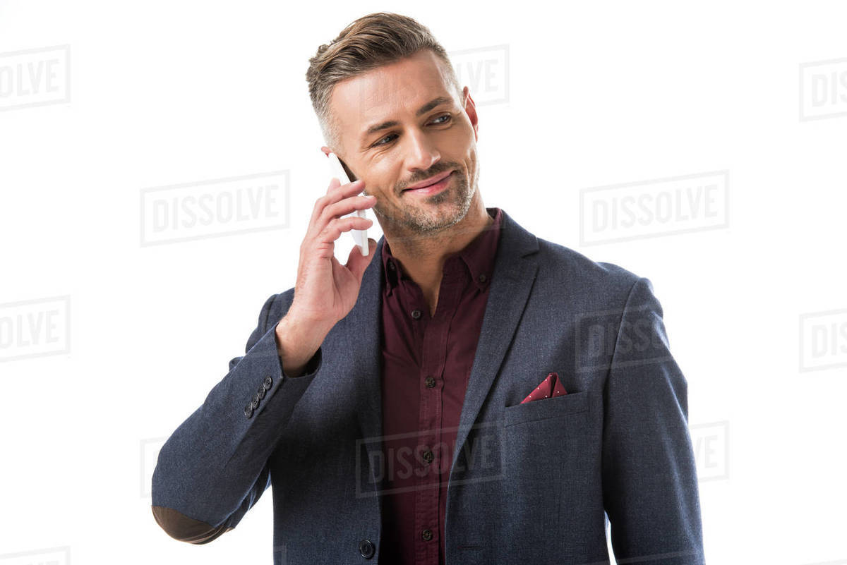 Handsome smiling stylish man talking on smartphone isolated on white ...