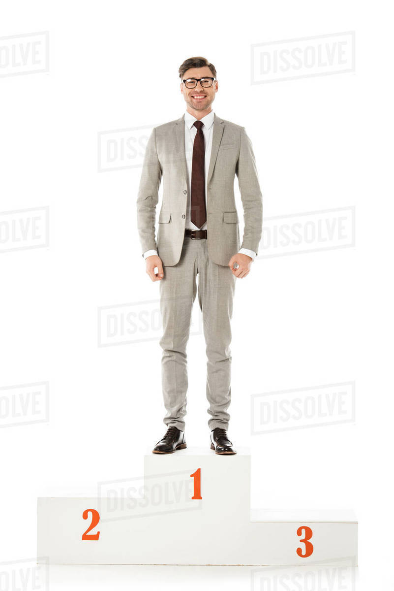 successful businessman standing on winners podium isolated on white ...
