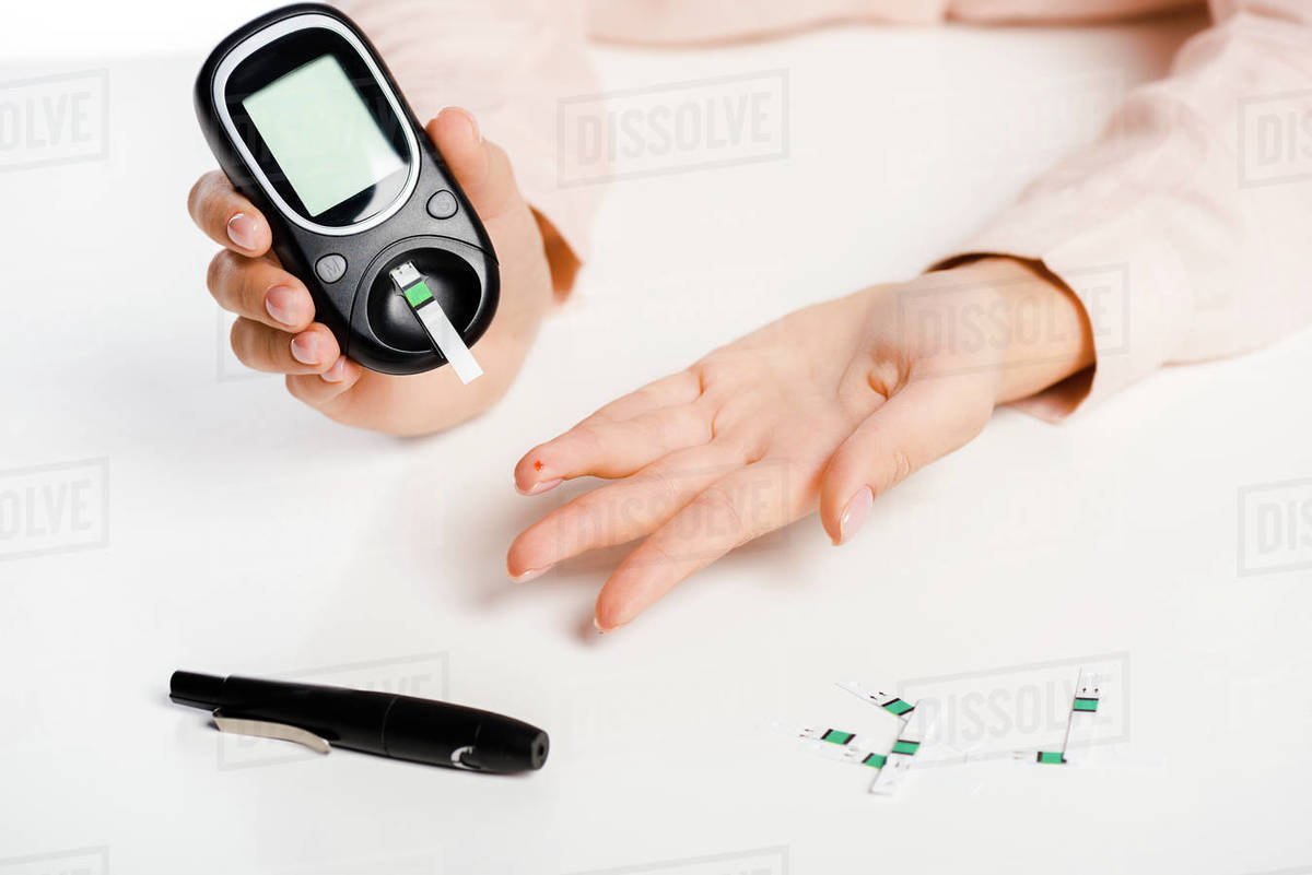 cropped image of woman measuring level of glucose in blood with ...