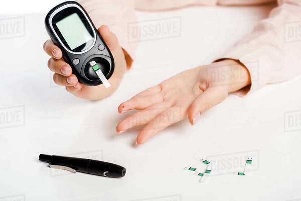 cropped image of woman measuring level of glucose in blood with ...