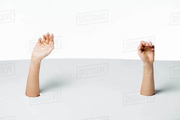 cropped shot of female hands through holes on white background ...
