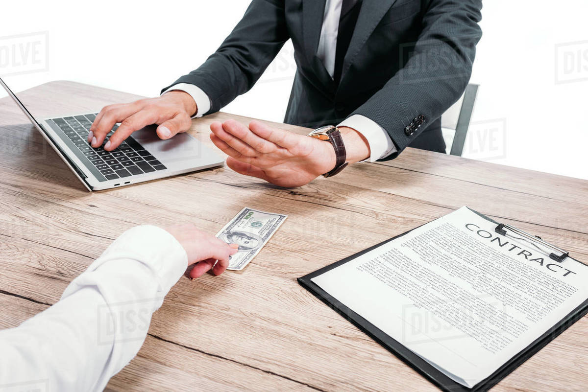 Cropped image of businessman rejecting bribe from colleague in office ...