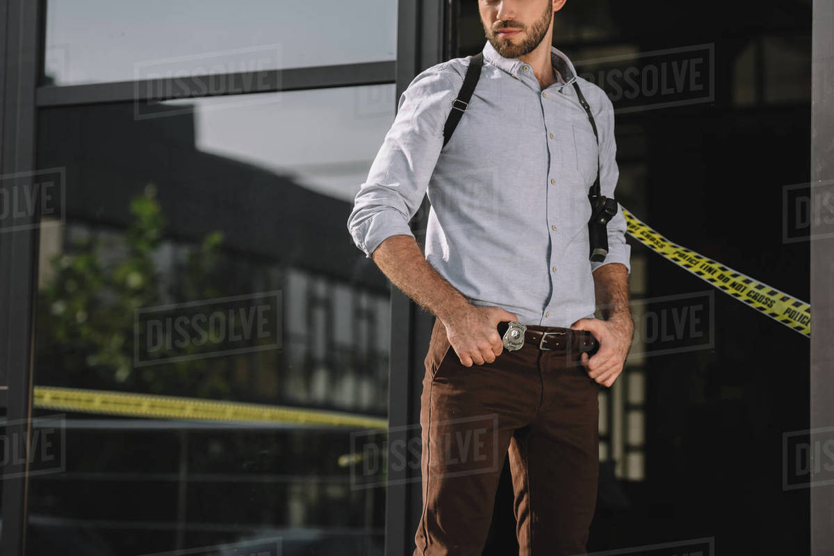 Male detective standing with arms akimbo - Royalty-free Stock Photo ...