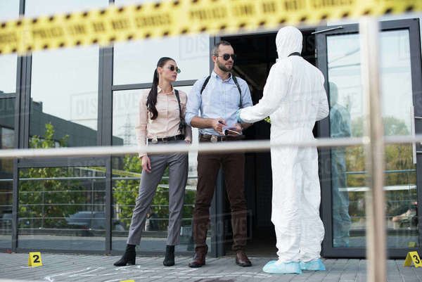 Male criminologist explaining his vision to two detectives - Royalty ...