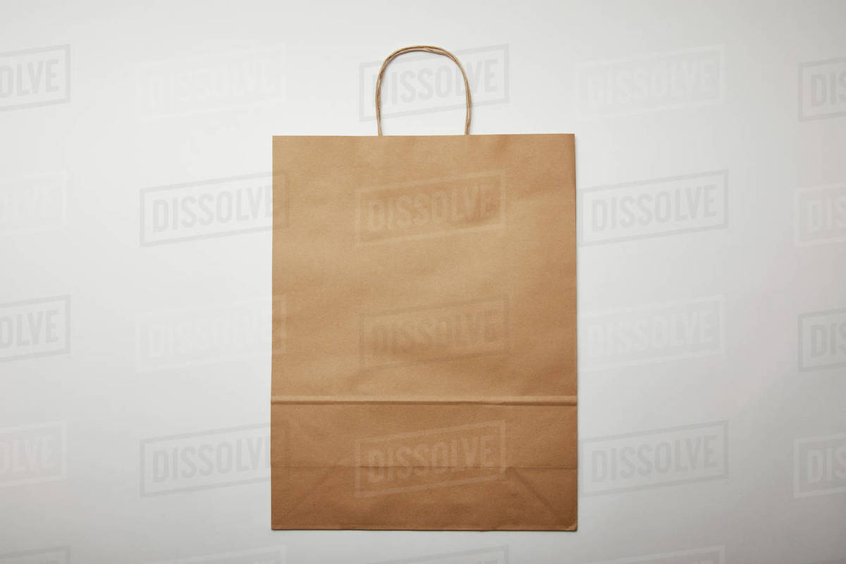 Top view of food delivery paper bag on white surface, minimalistic ...